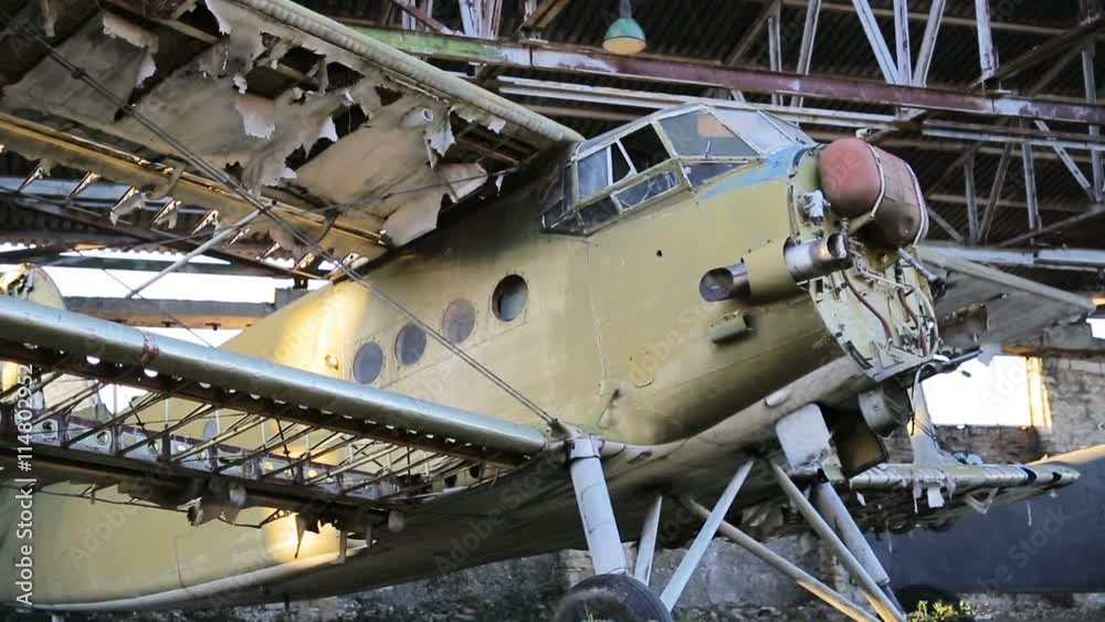 Old Soviet military airplane in an abandoned hangar.Old biplane.Vintage ...