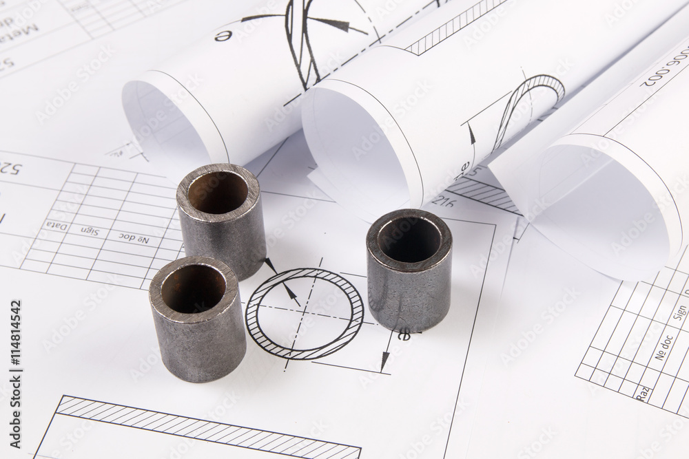 Metal cylinders on printed engineering drawings. Mechanics and ...