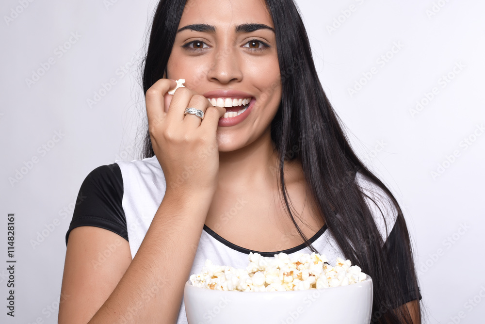 Young woman eating popcorn Stock Photo | Adobe Stock
