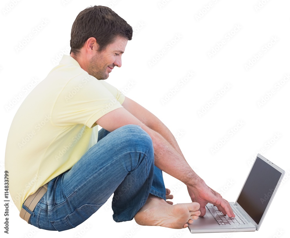 Smiling man using a laptop Stock Photo | Adobe Stock