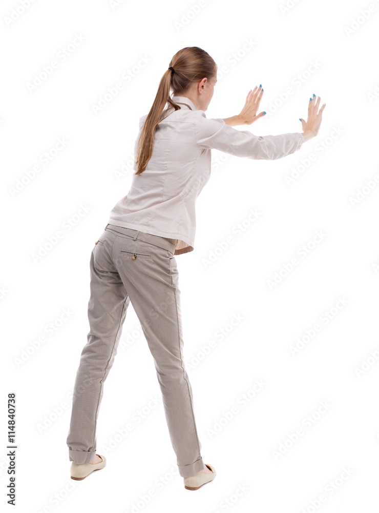 back view of woman pushes wall. Stock Photo | Adobe Stock