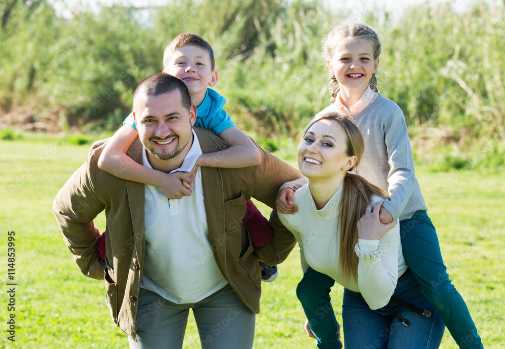 Parents holding kids on shoulders Stock Photo | Adobe Stock