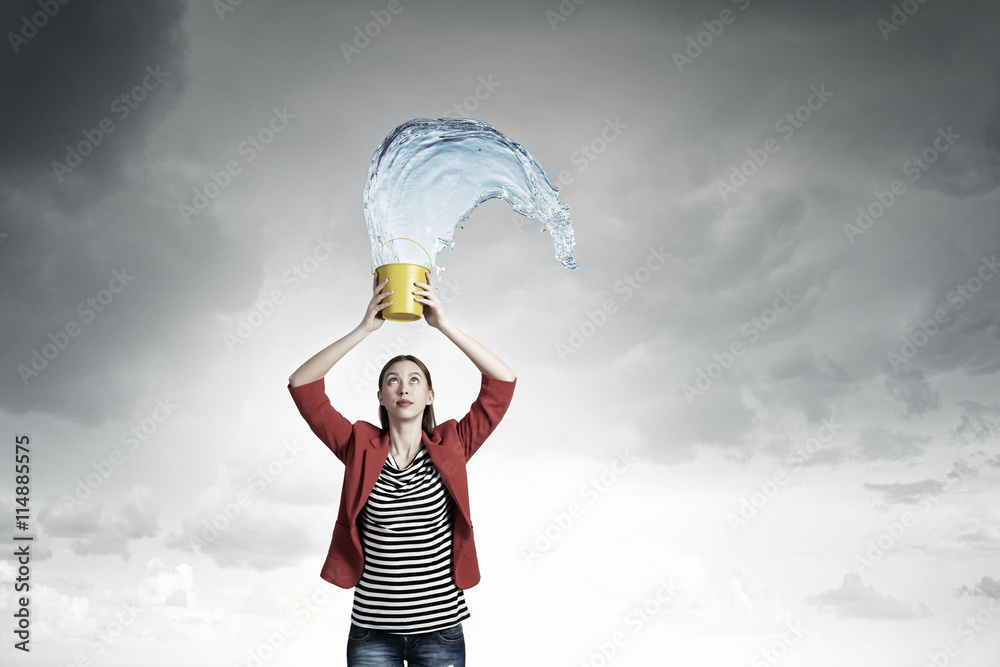 Girl pouring water from bucket . Mixed media Stock Photo | Adobe Stock