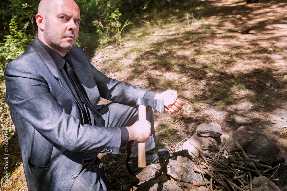Crazy bald guy in a suit with an axe Stock Photo | Adobe Stock