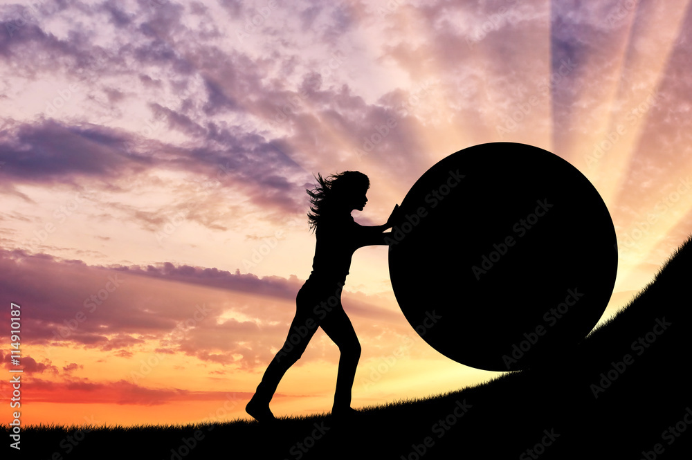 Silhouette of a strong woman pushing a stone up. Stock Photo | Adobe Stock