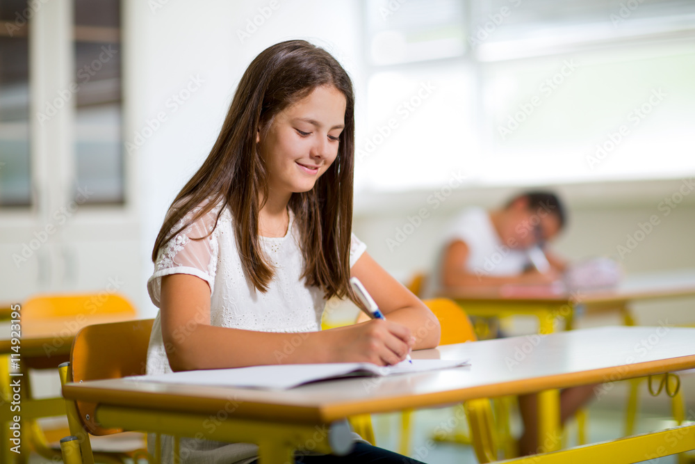 Two girls sitting in a school classroom and learning Stock Photo ...