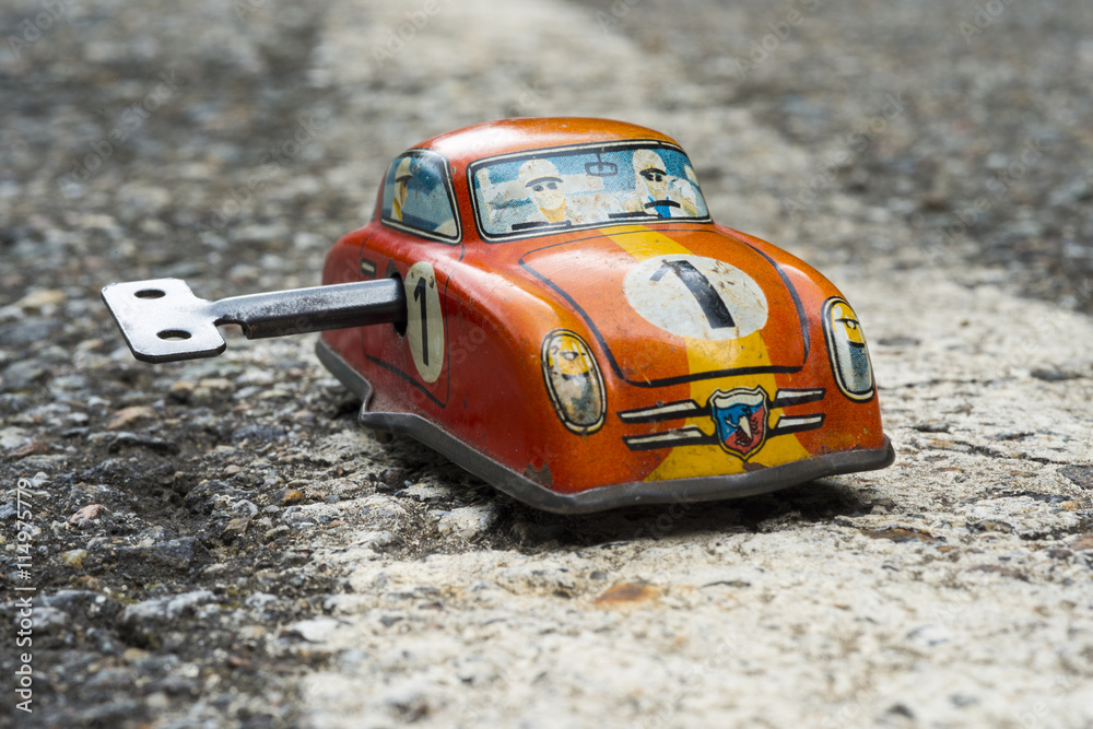 Clockwork toy car on asphalt background Stock Photo | Adobe Stock