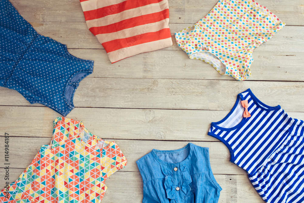 Beautiful kidswear on a white wooden background Stock Photo | Adobe Stock