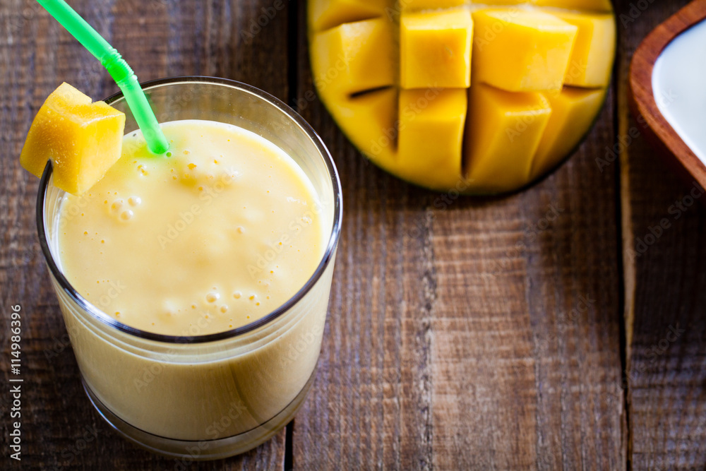 Glass of mango lassi, Indian drink made from yogurt with blended mango ...