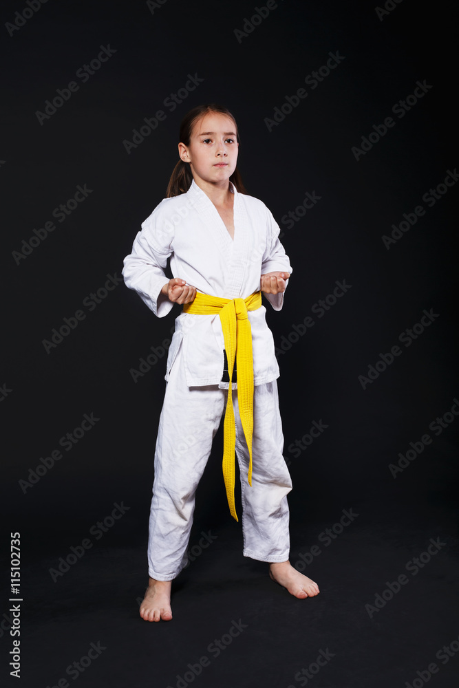 Child girl in karate suit with yellow belt show stance Stock Photo ...
