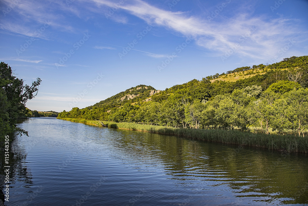 Quiet river flows through a hilly area Stock Photo | Adobe Stock