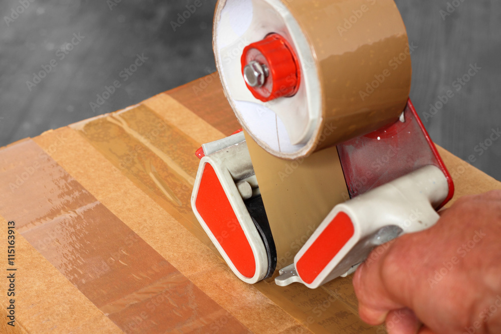 Taping box tape dispenser / Man taping a cardboard box with a tape ...