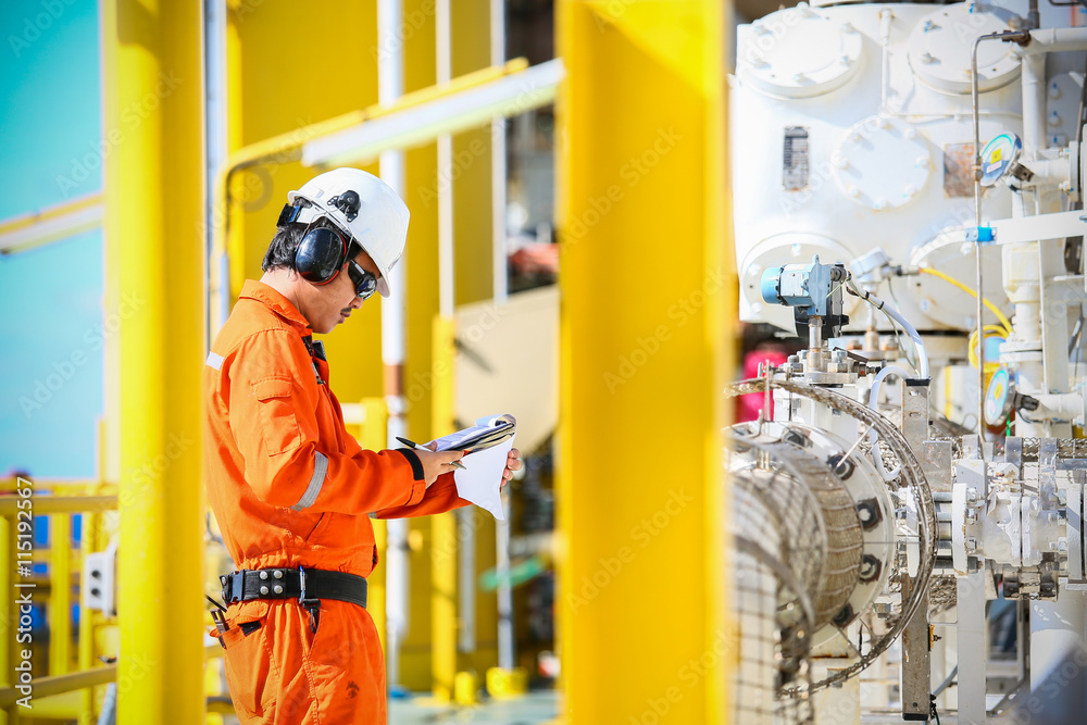 operator recording operation of oil and gas process at oil and rig ...