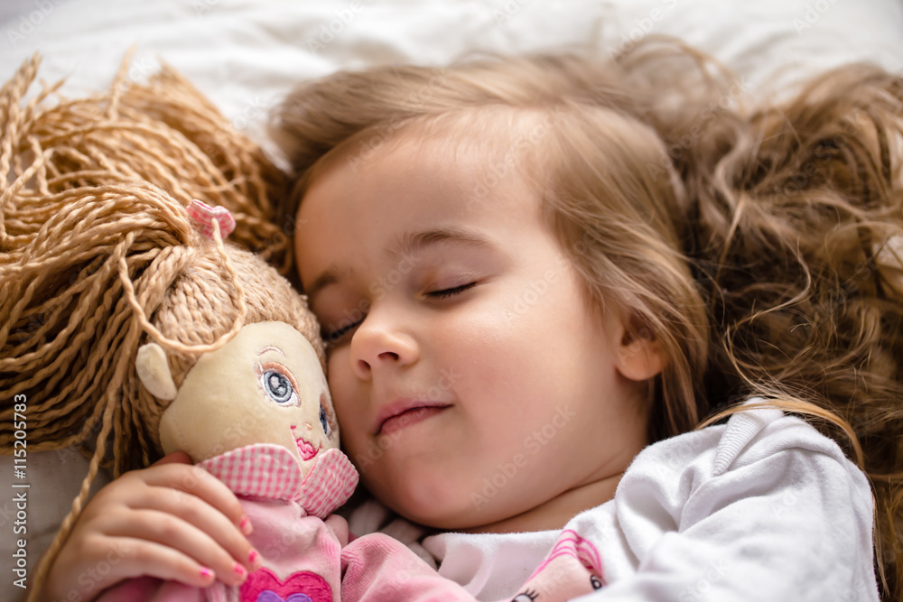 little girl falls asleep in bed with soft doll white Stock Photo ...