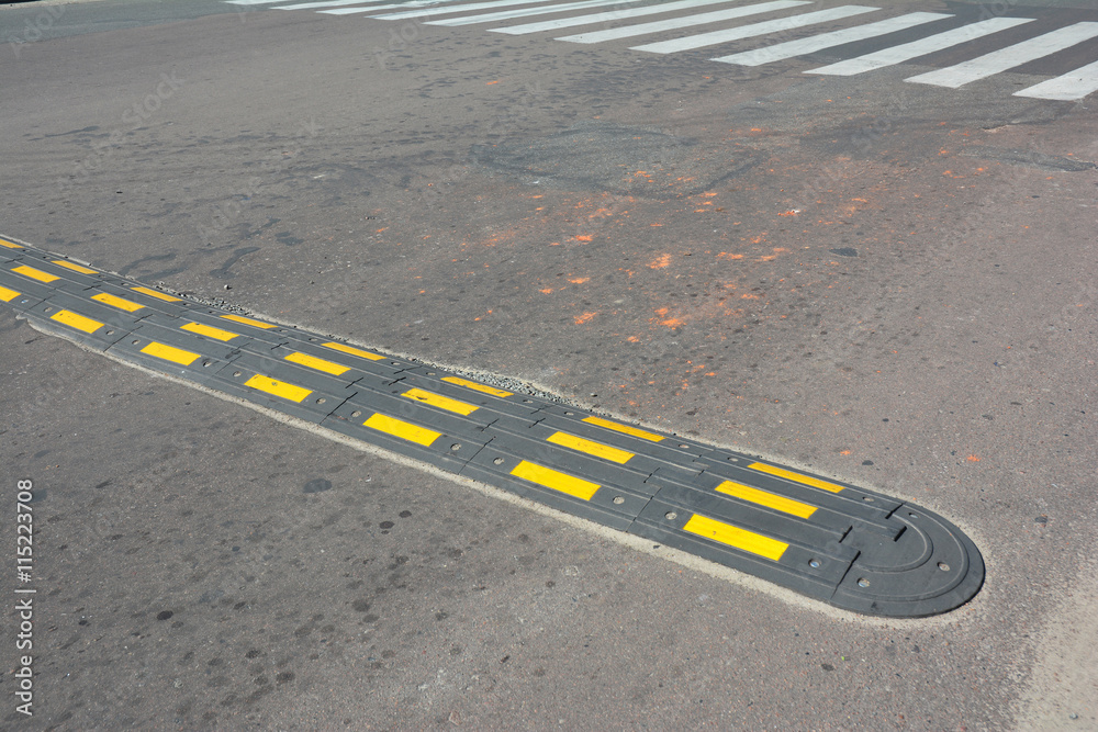 Traffic safety speed bump with crosswalk on an asphalt road. Speed ...