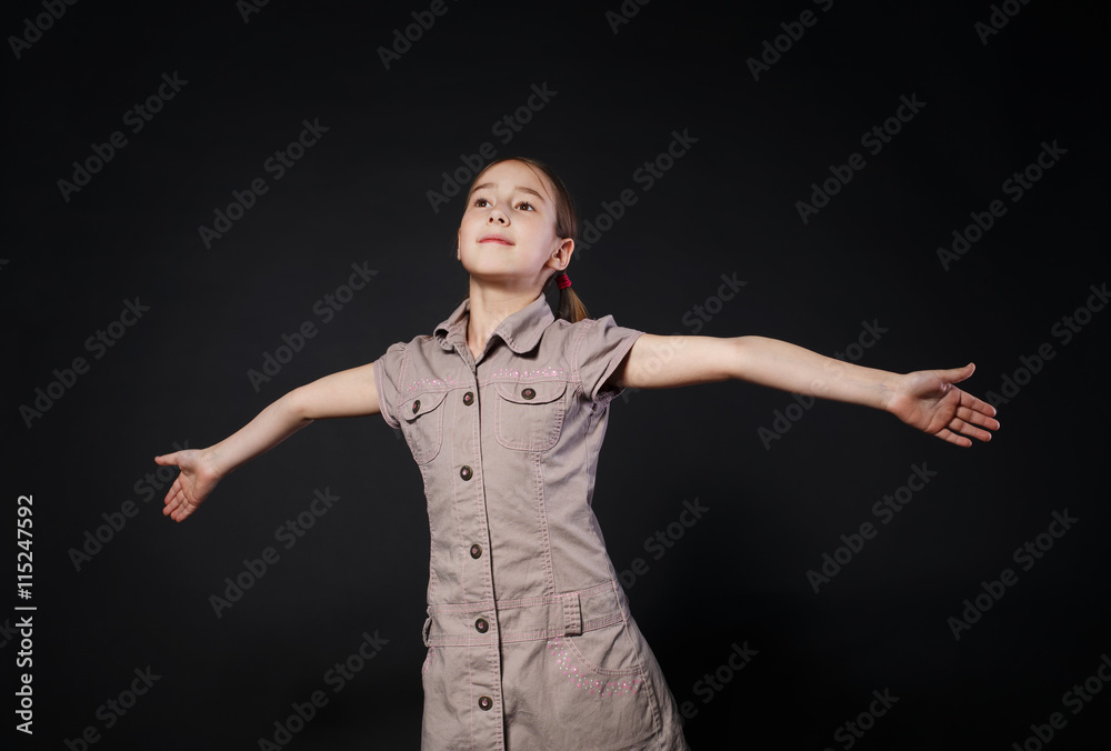 Small girl openes hands in fly gesture at black background Stock Photo ...