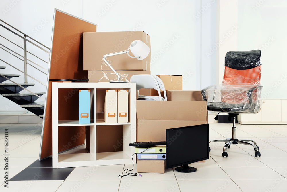 Move concept. Unpacking cardboard boxes in a new office Stock Photo ...