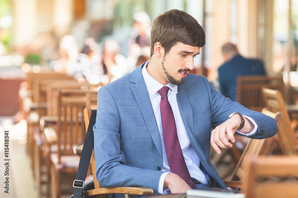 Handsome man looking time at watch Stock Photo | Adobe Stock