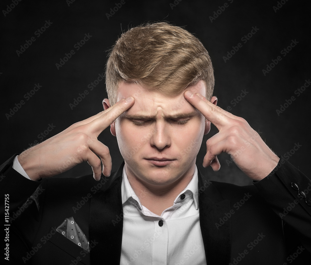 Man feeling a headache or intensely thinking. Stock Photo | Adobe Stock