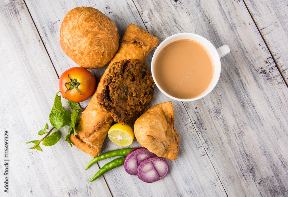 coriander vada or kothimbir vada, samosa, kachori, daal vada on brown ...