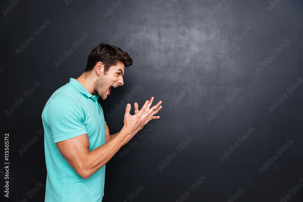 Side view of a angry man screaming over black background Stock Photo ...
