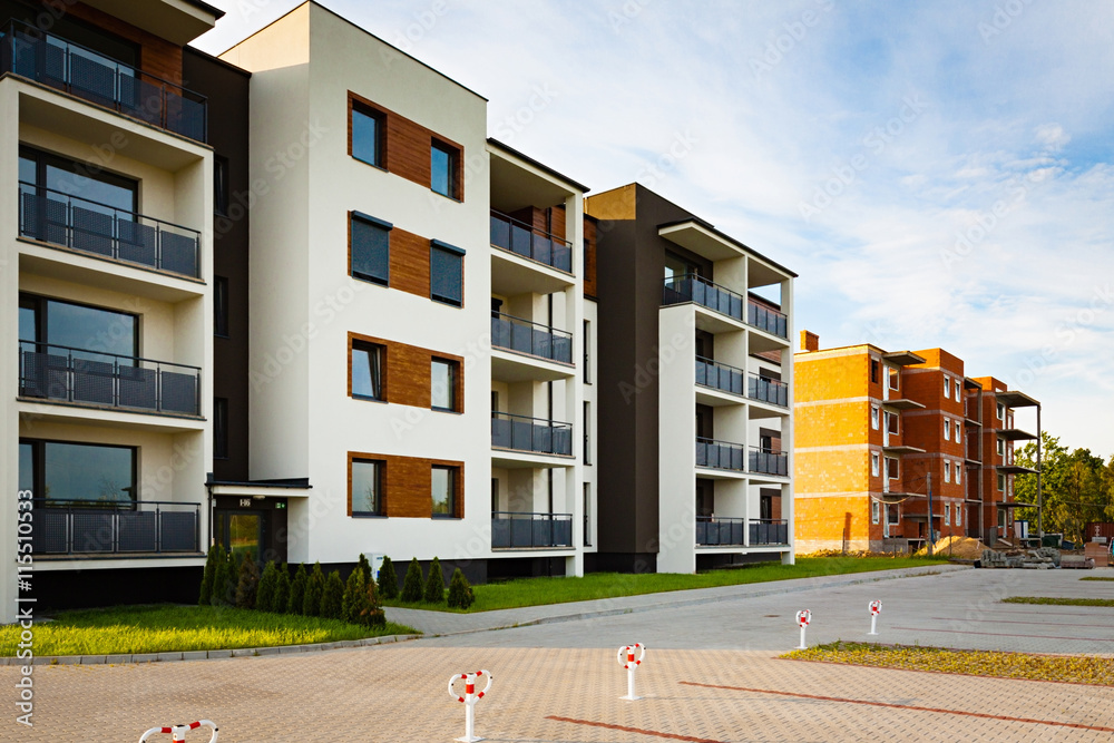New multi-family block with balconies and bright facade decorated with ...