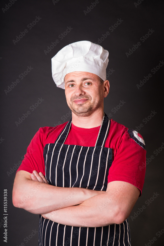 Handsome chef posing against black background Stock Photo | Adobe Stock