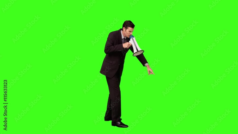 Businessman standing and shouting with megaphone on green screen ...