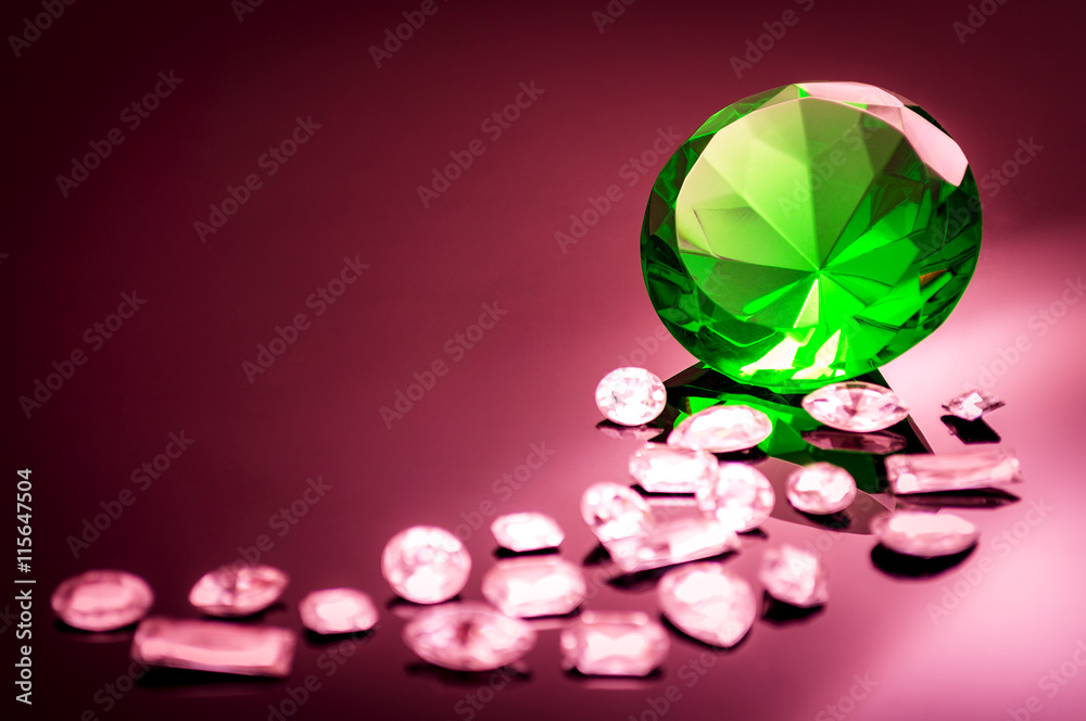 Giant green emerald on a red/ pink background surrounded by precious ...