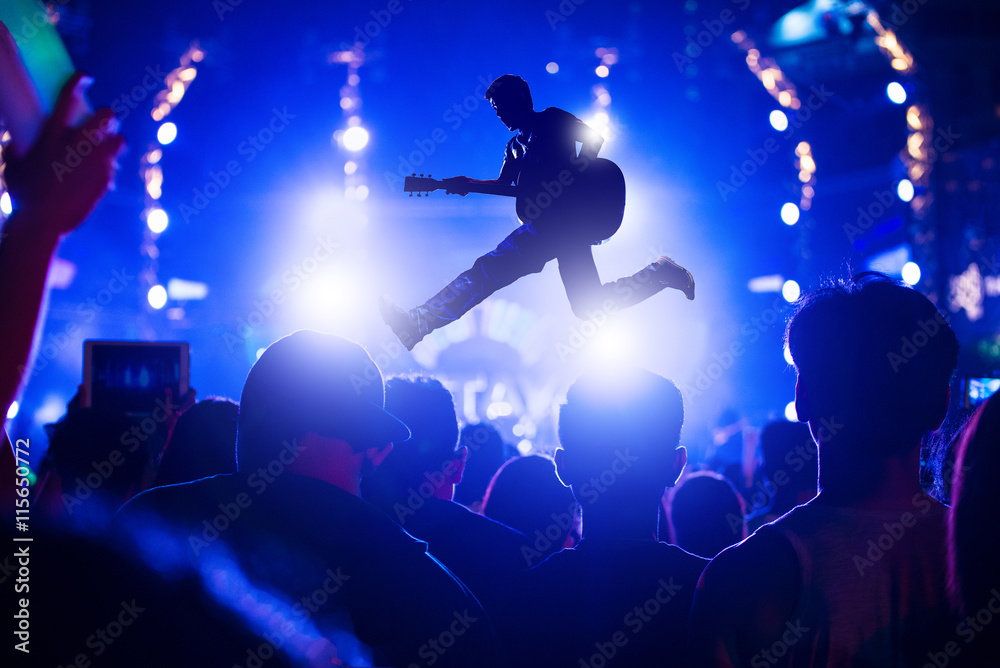 Singer singing on concert stage with ray of illuminated, Singer and ...