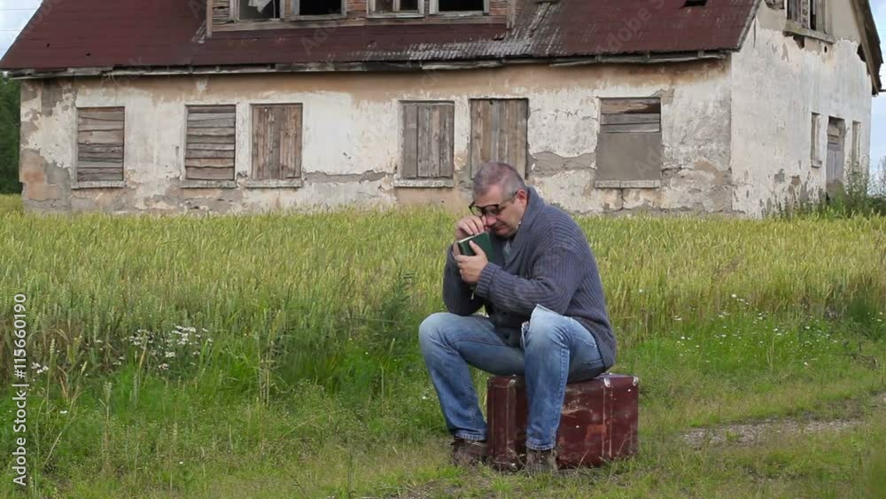 Man sitting on suitcase and crying Stock Video | Adobe Stock