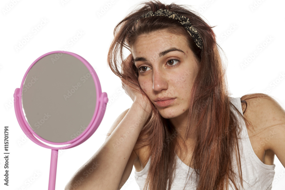 Fotografia do Stock: young depressed and sad girl looking in the mirror ...