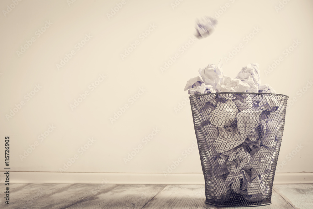 Crumpled paper in the trash can Stock Photo | Adobe Stock