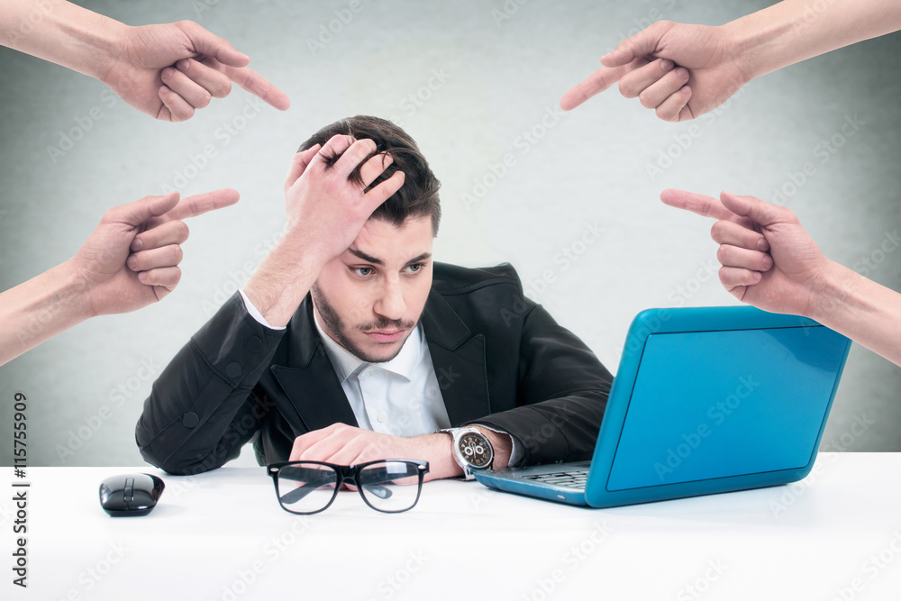 Foto de Mobbing concept. Young employee with many arms pointing at him ...