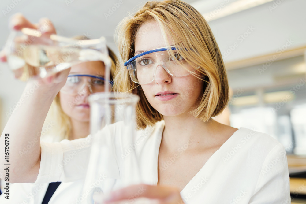 Students performing experiment in science classroom Stock Photo | Adobe ...