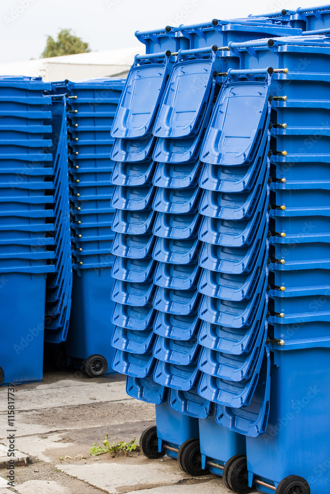 Poster Stack of blue industrial trash bins outdoors. – Wall Art | UkPosters