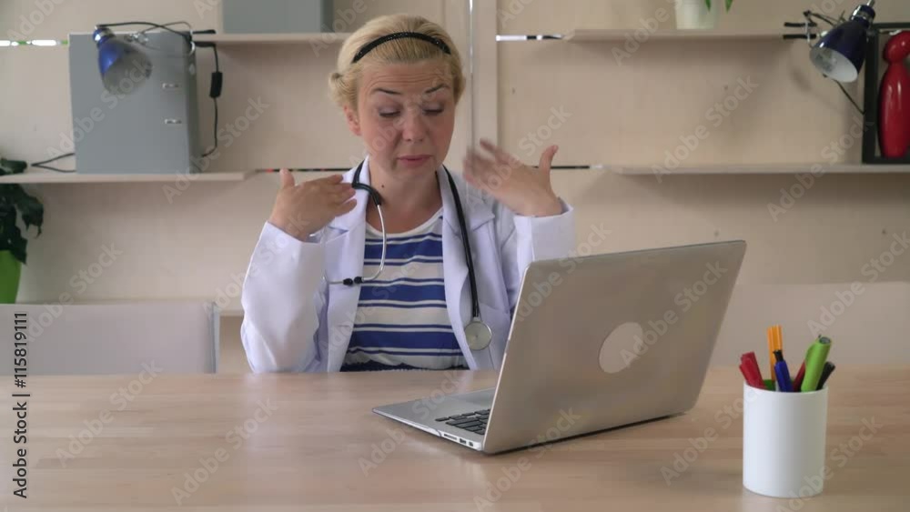 Doctor fanning herself with her hand. Middle aged woman working in ...
