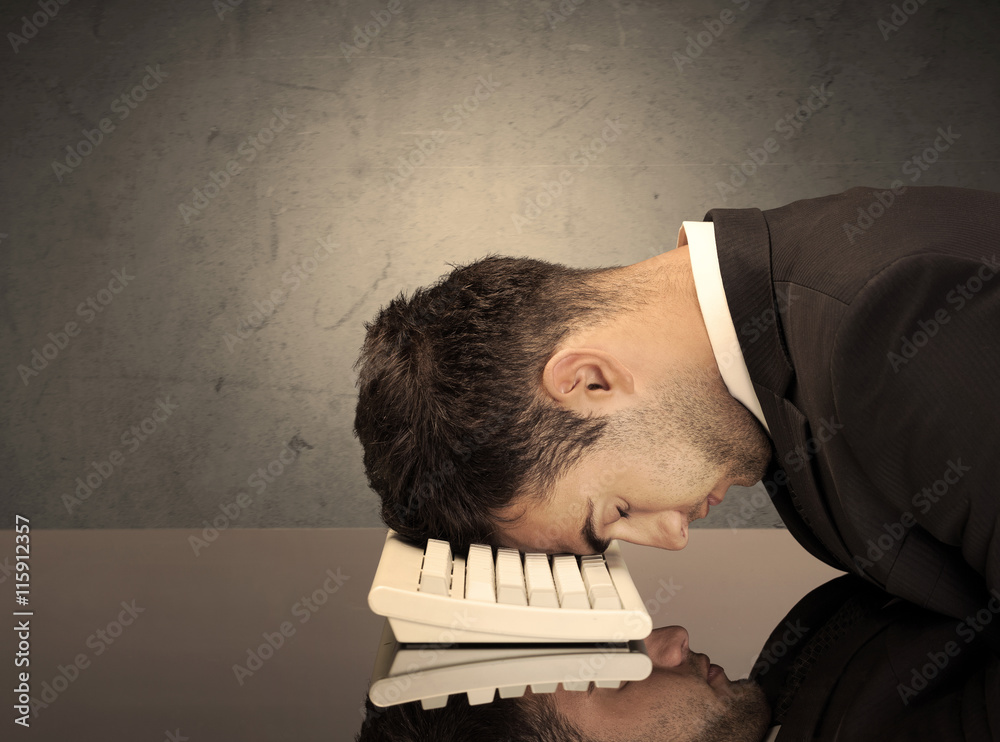 Frustrated businessman's head on keyboard Stock Photo | Adobe Stock