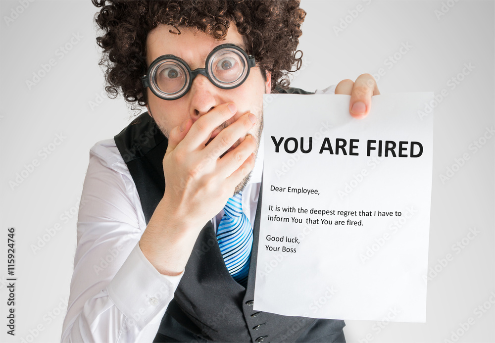 Shocked employee is showing letter with You are fired message. Stock ...