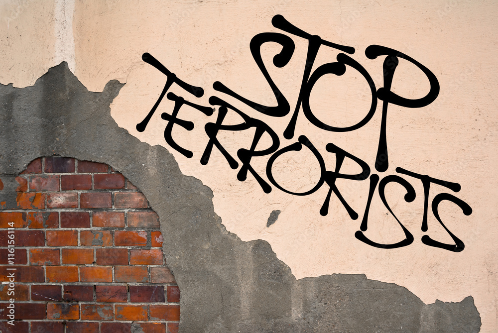 Stop Terrorists - Handwritten graffiti sprayed on the wall, anarchist ...