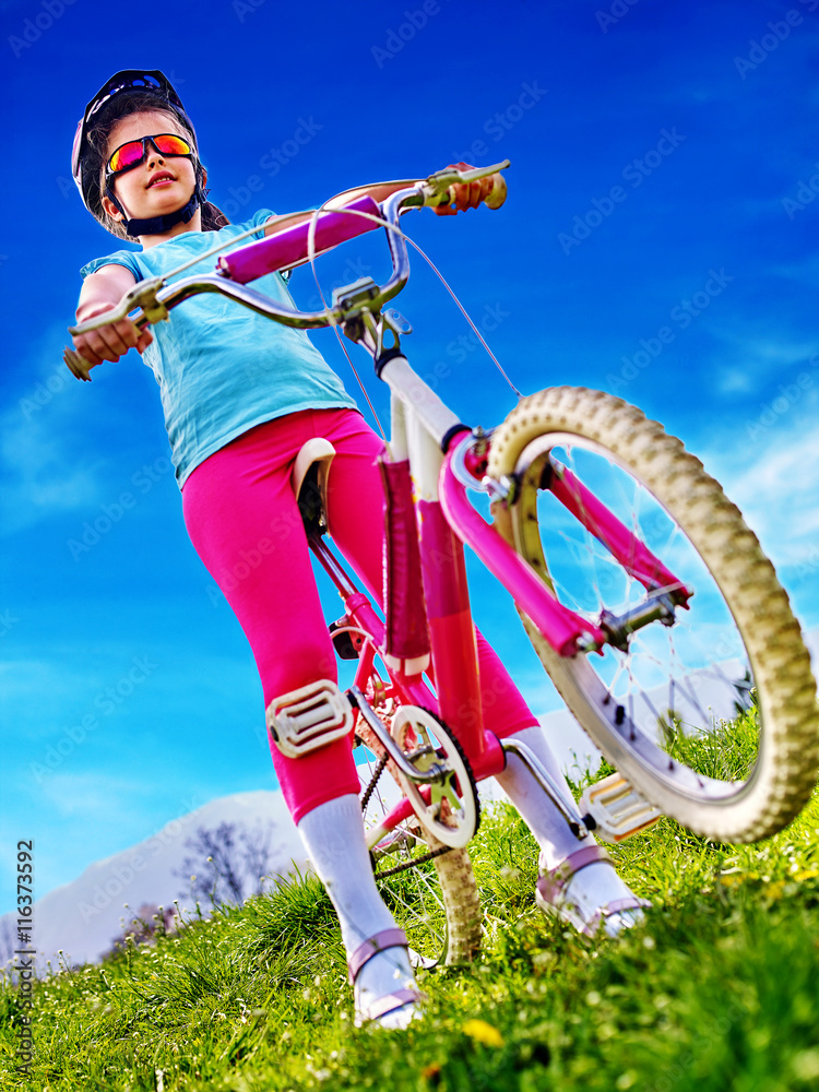 Bicycle child. Child wearing bicycle helmet rides bicycle and look at ...