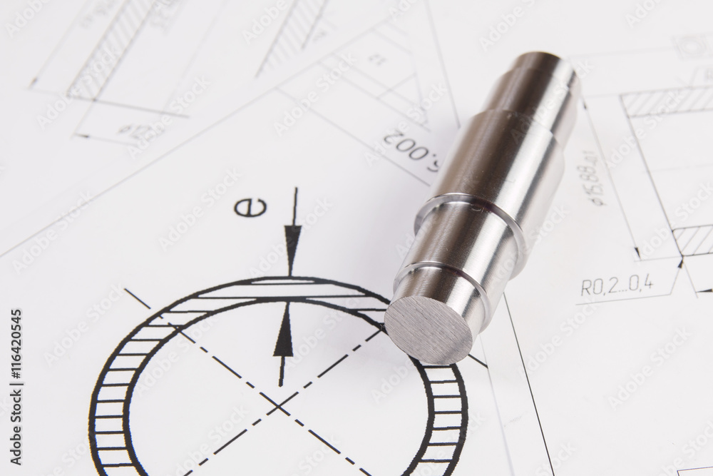 Metal cylinders on printed engineering drawings. Mechanics and ...