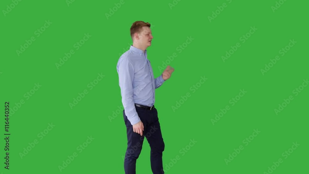 portrait of young caucasian man standing against green screen ...