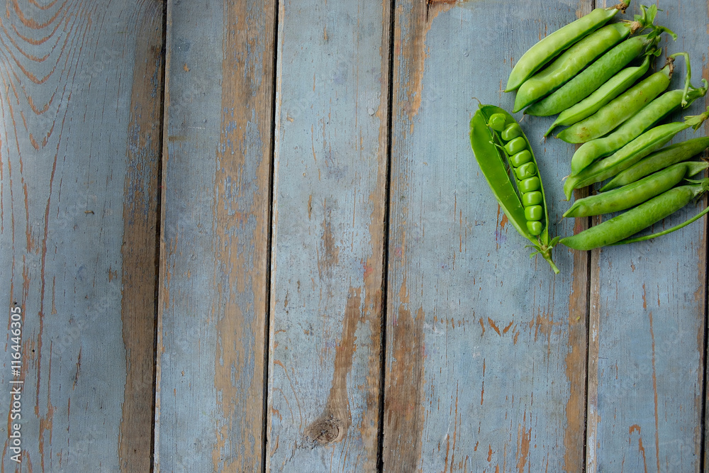 Green peas in pods freshly picked on rustic wooden tableod background ...