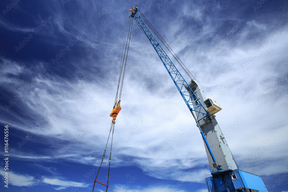 Overhead crane at port lifting heavy load Stock Photo | Adobe Stock