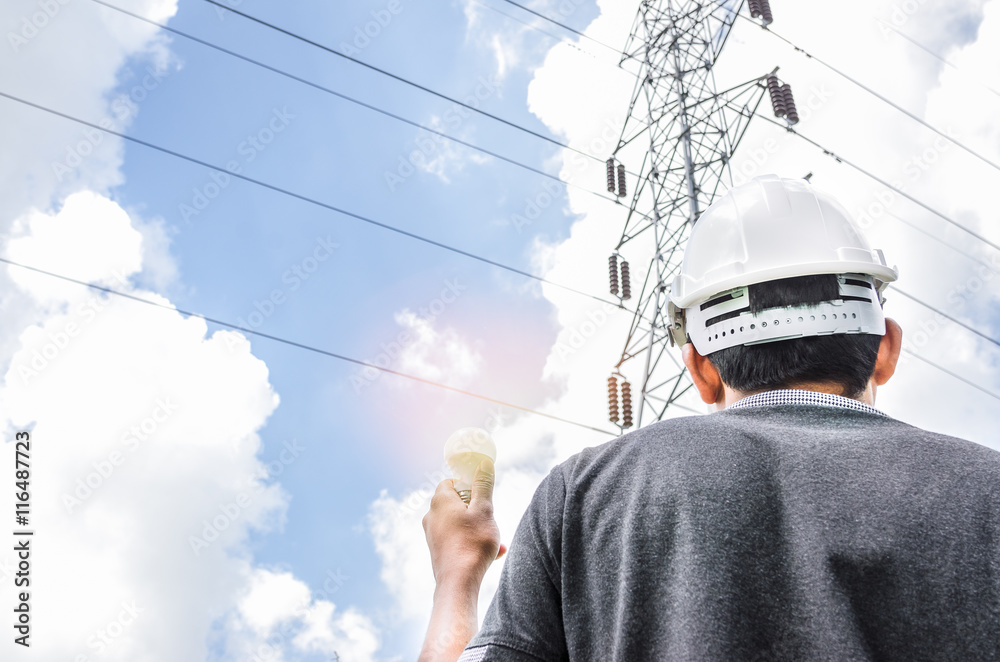 High-voltage tower with blue sky background And electrical engineers ...