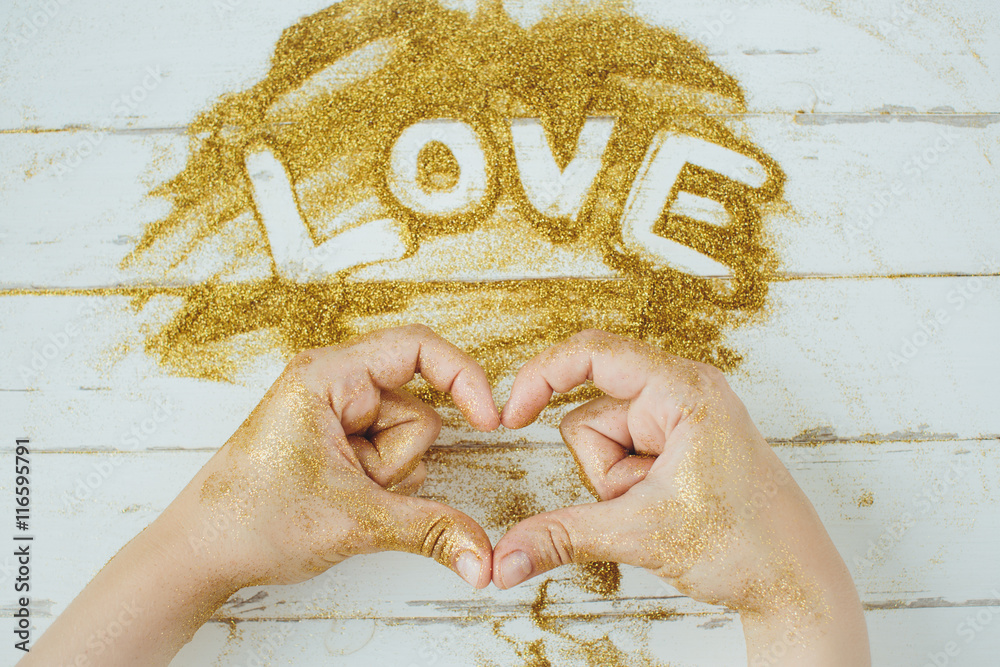 Gold Glitter on hands with love shape Stock Photo | Adobe Stock