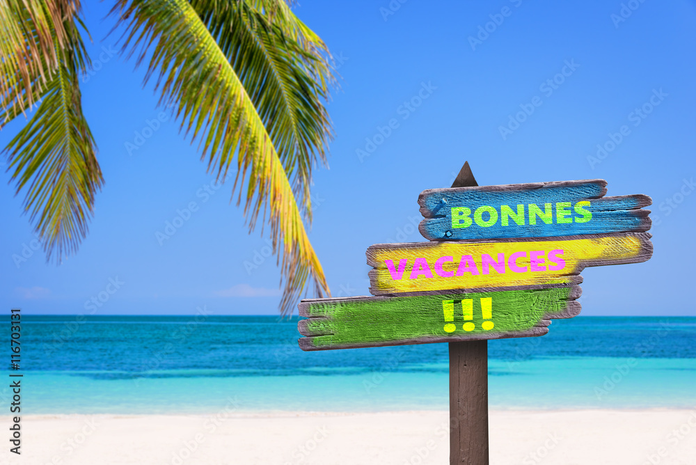Bonnes vacances écrit sur un panneau en bois coloré, fond plage et ...