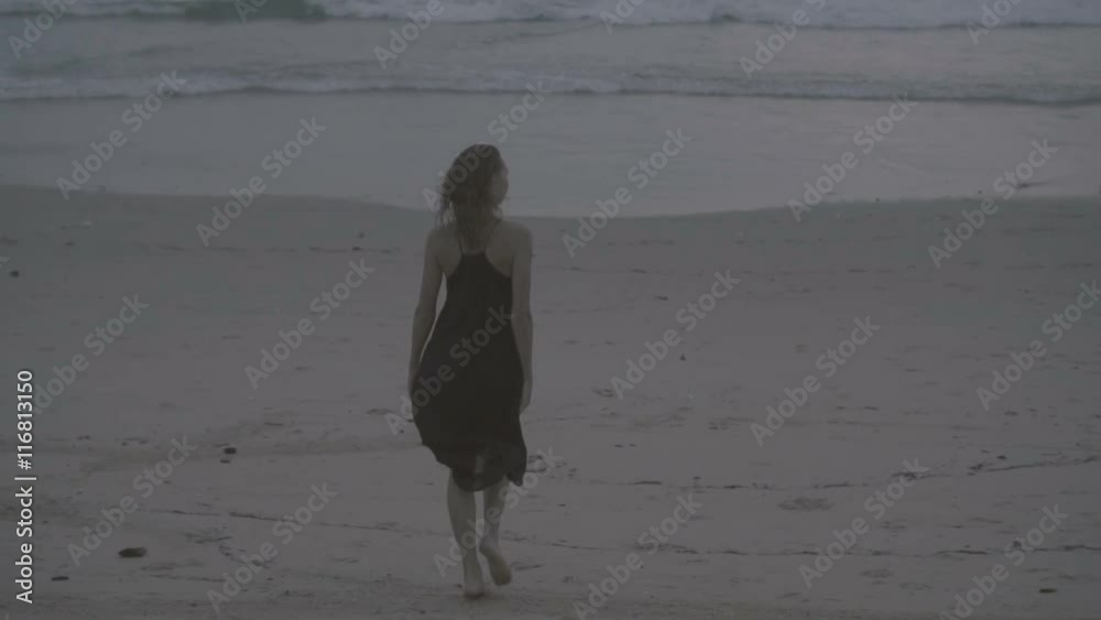 Back view of beautiful blonde glamour woman wearing black dress walking ...