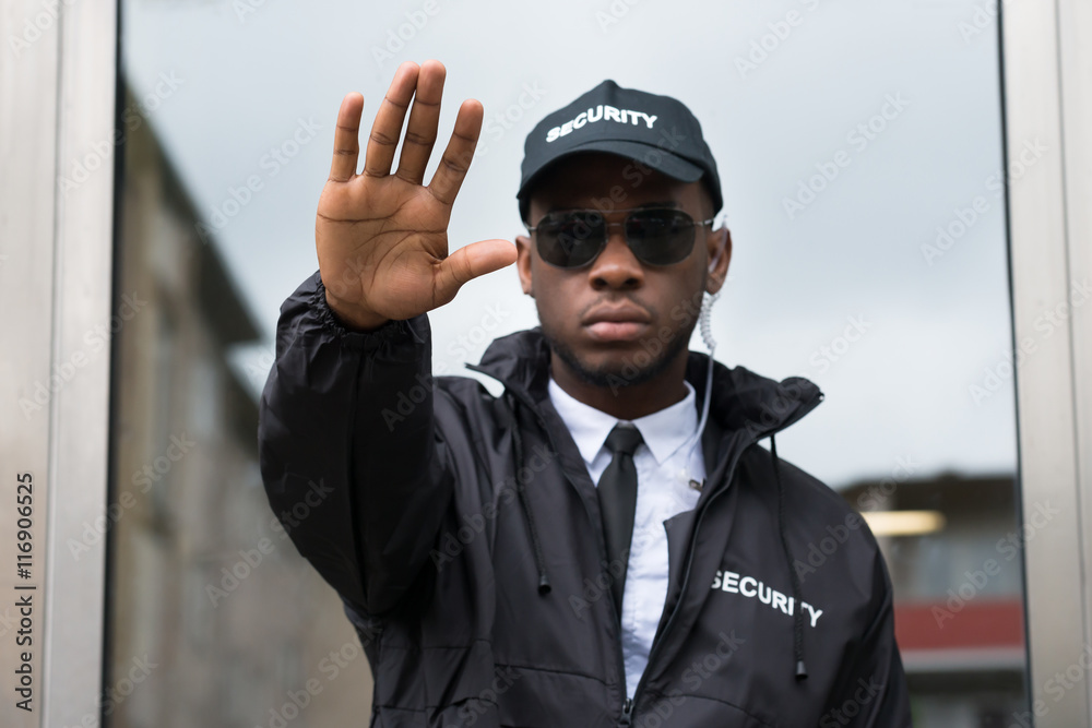 Security Guard Making Stop Gesture Stock Photo | Adobe Stock